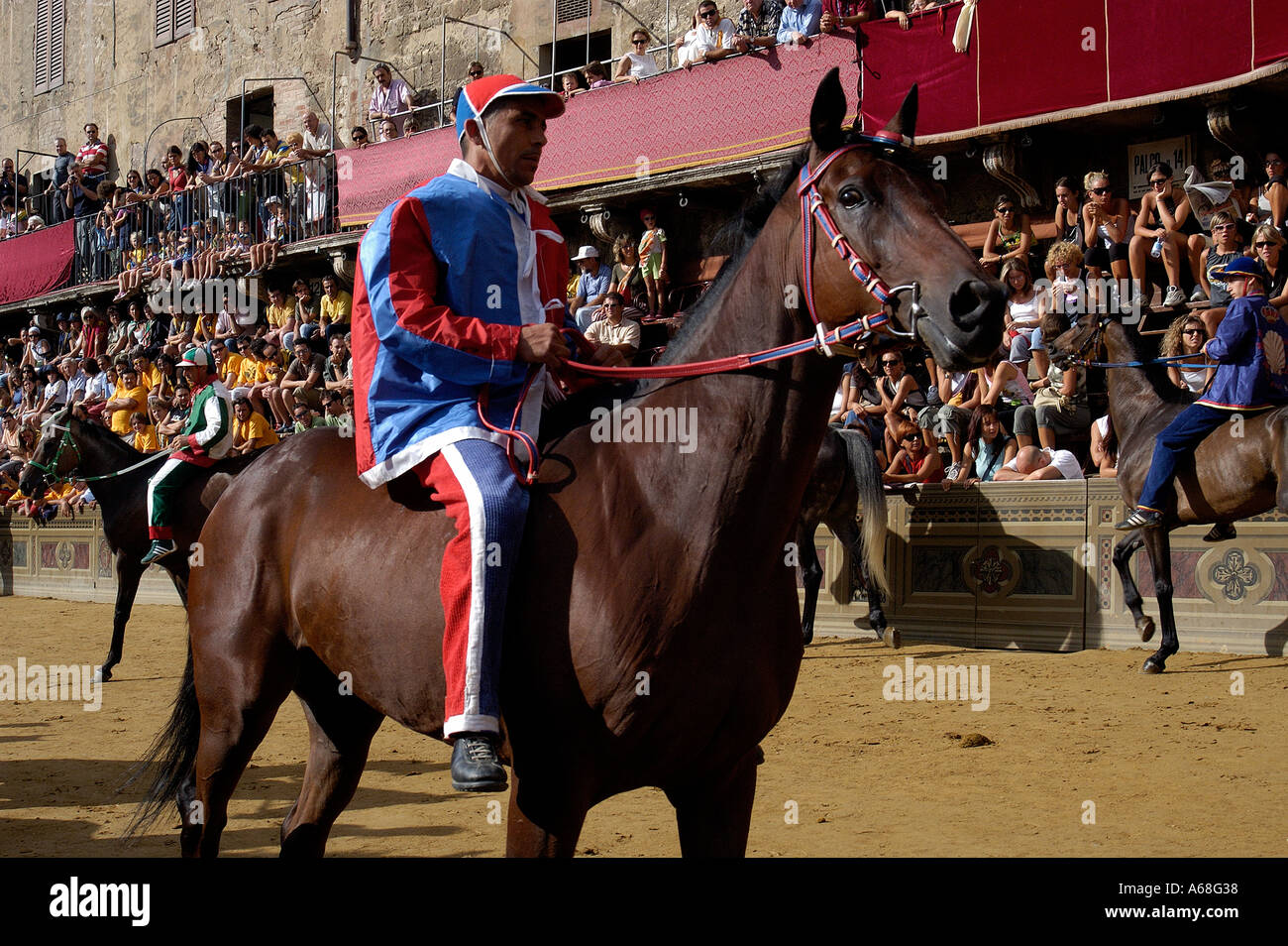 Jockeys dressed in colourful medieval costume line up for the start of ...