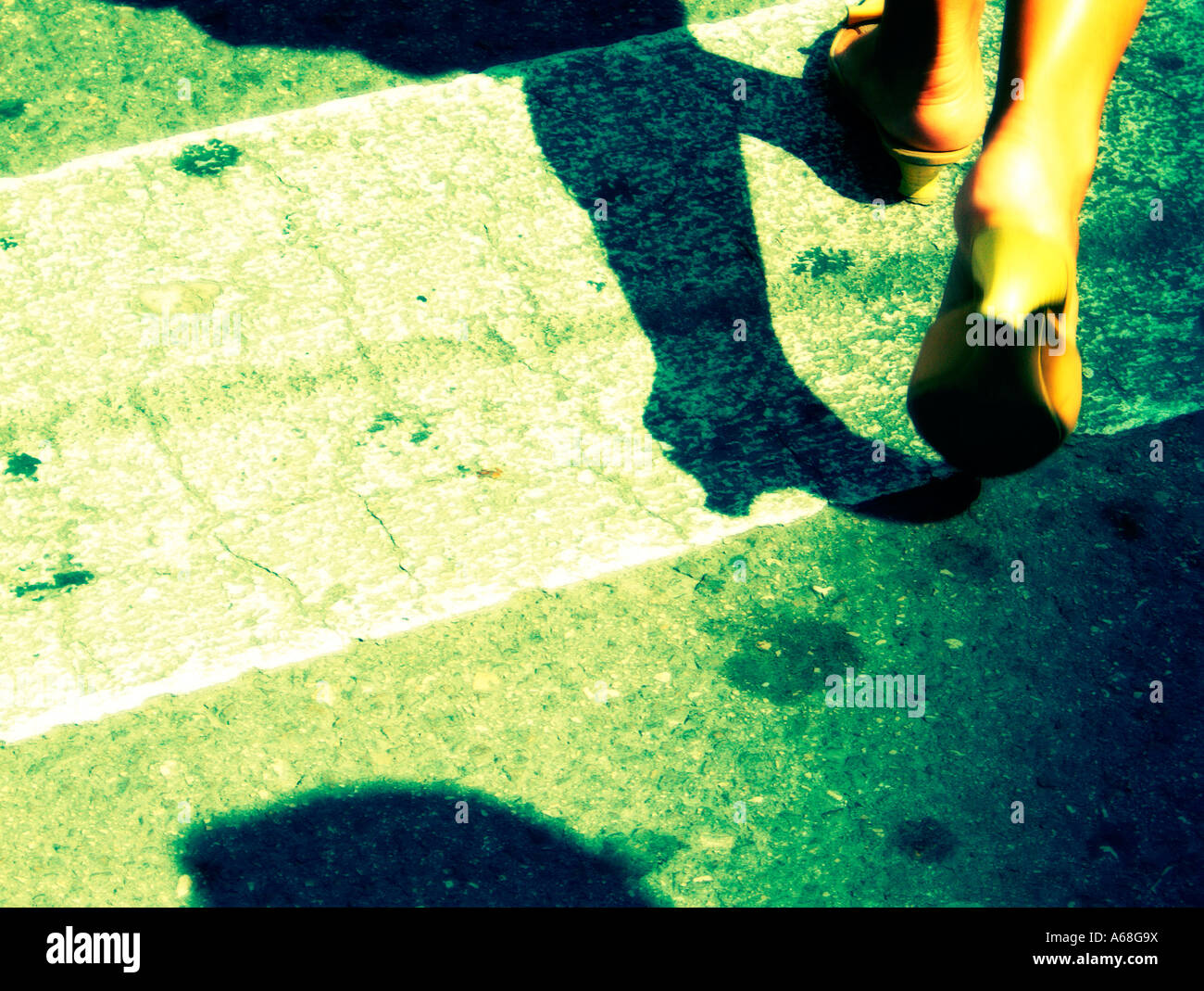 Woman walking over a zebra crossing Stock Photo - Alamy