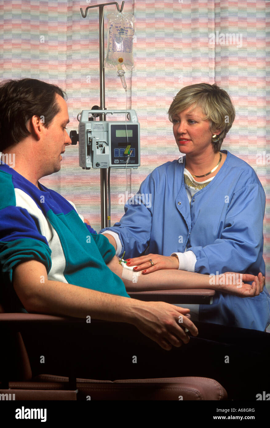 Nurse administering chemotherapy to a patient Stock Photo - Alamy