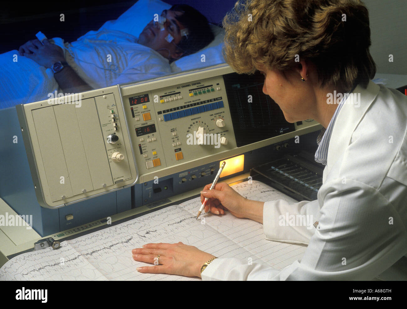 Technician monitors patient brain activity in sleep disorder lab Stock ...