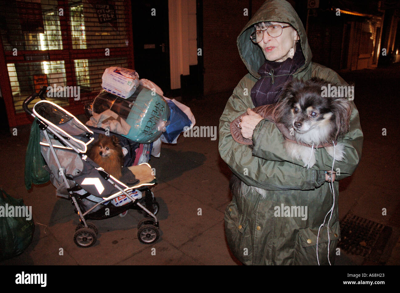Woman who walks the street at night collecting reject discarded clothes ...