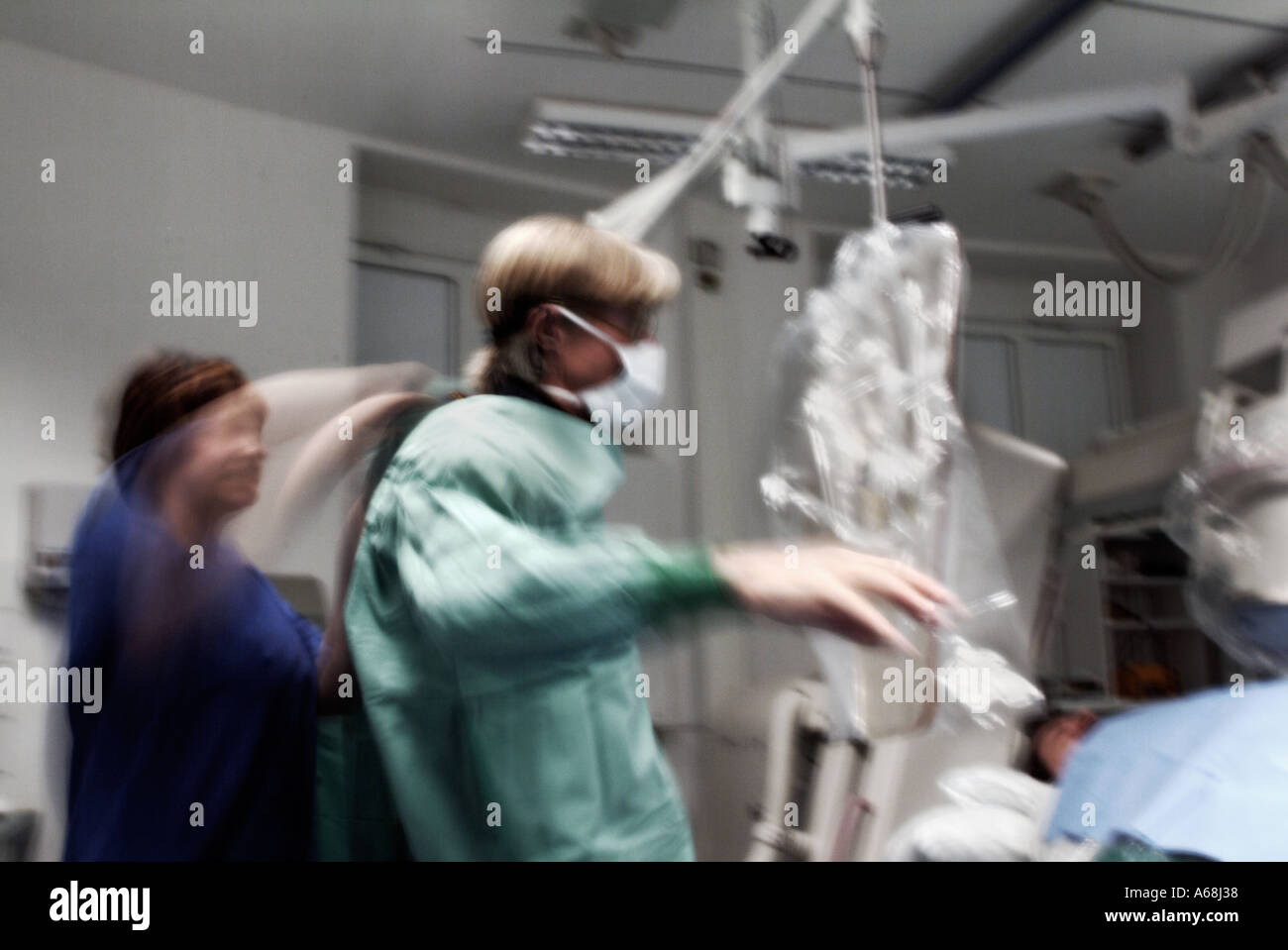 Nurse assisting a surgeaon prior surgery in busy operation theatre ...