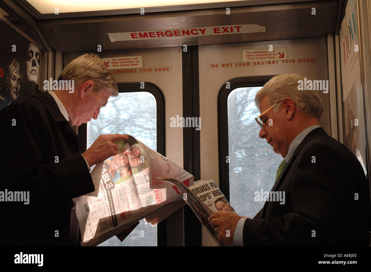 Commuters reading newspapers travelling into New York by train to work ...