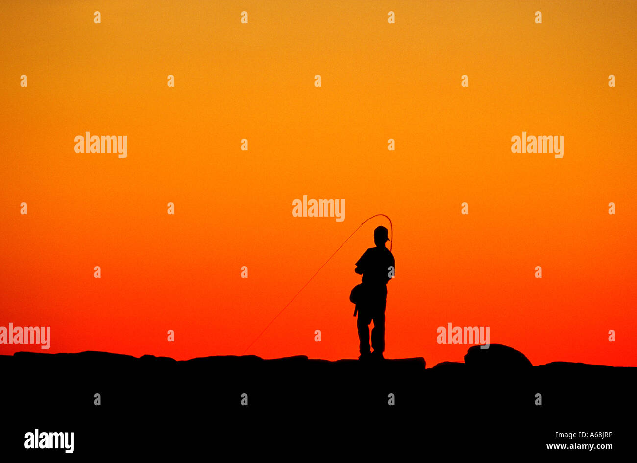 Boy fishing from a jetty at sunset Menemsha, Martha"s Vineyard ...