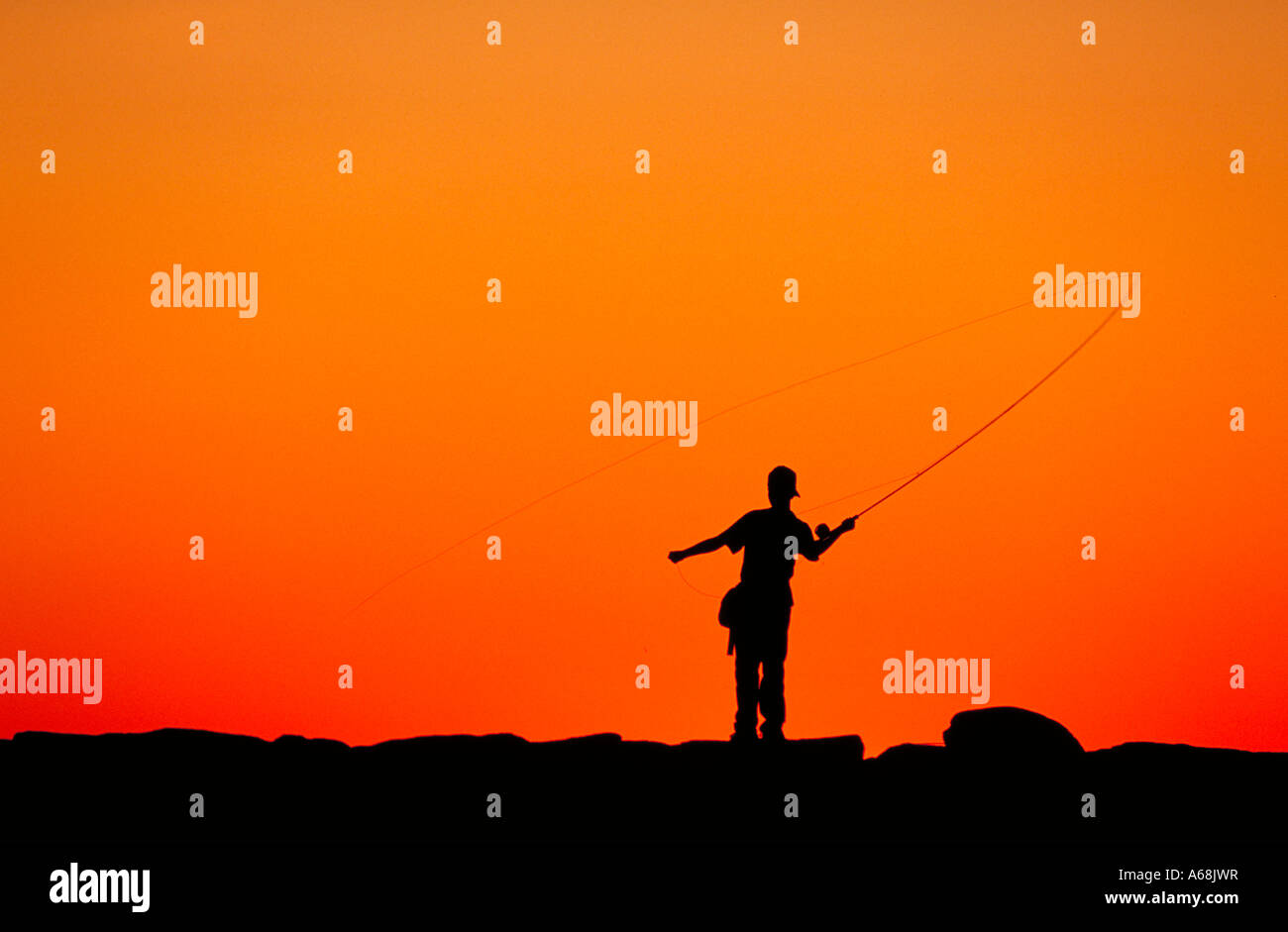 Boy fishing from a jetty at sunset Menemsha Martha s Vineyard Stock ...