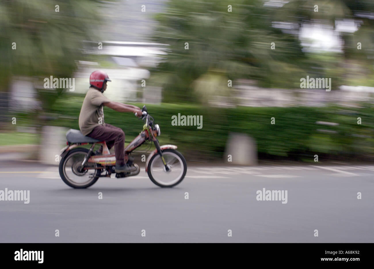 man riding a moped Stock Photo - Alamy