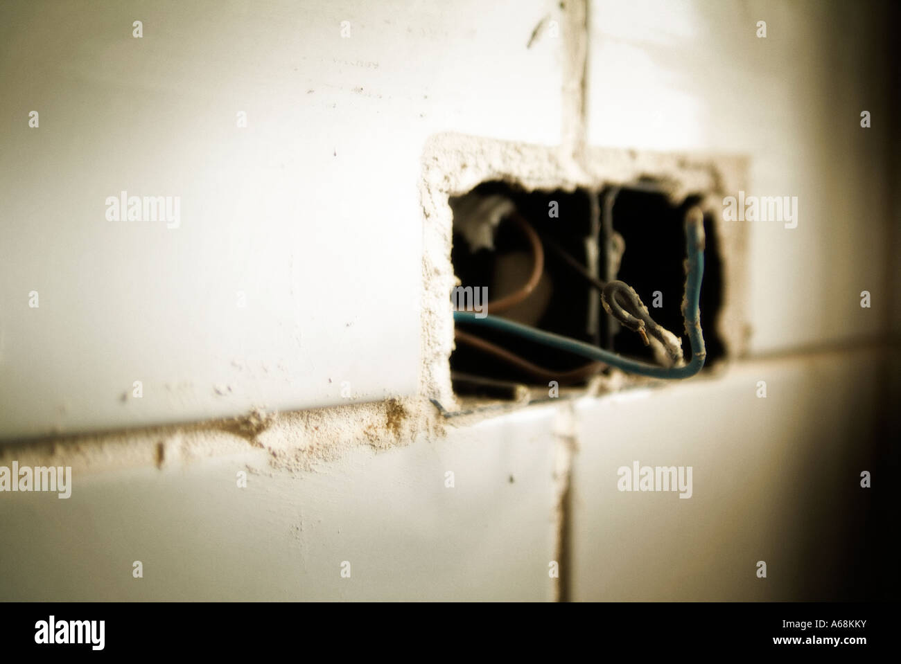 New glazed tiles in a restored wall and electrical line Stock Photo - Alamy