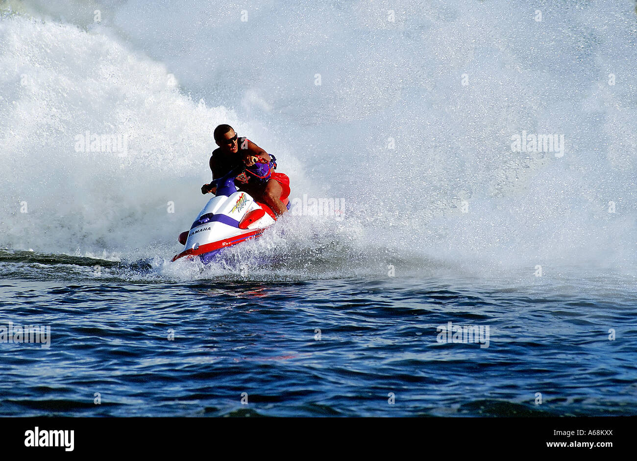 Man on a wave runner creates huge wave Stock Photo - Alamy