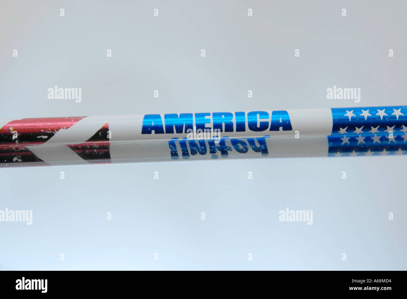 Wooden lead pencil laying on a mirror with America United wording and ...