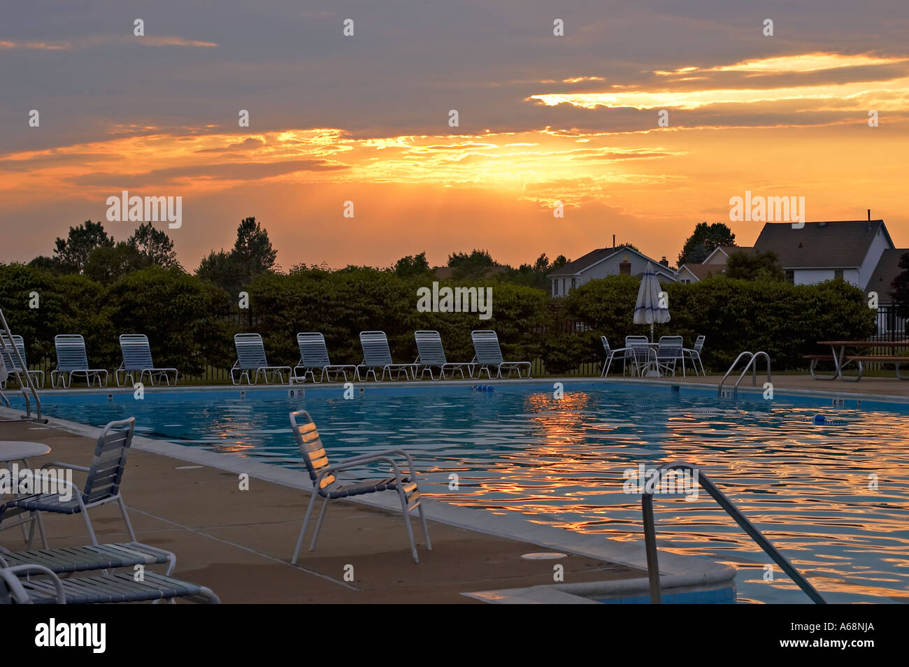 Swimming pool at sunset Stock Photo - Alamy