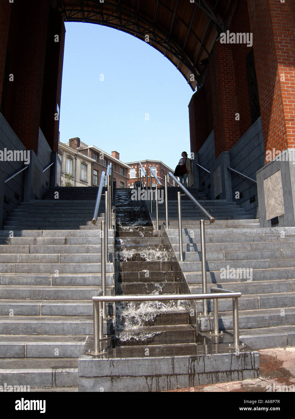 Waterfall falling through stairs and handrails. Downtown. Charleroi ...