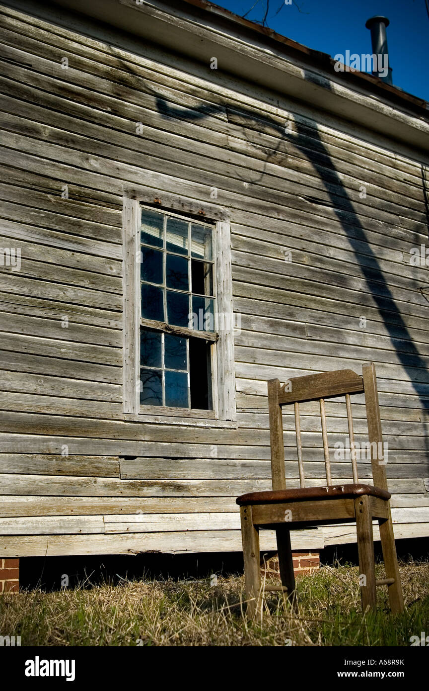 Old chair sitting outside a old broken down abandoned house Stock Photo ...
