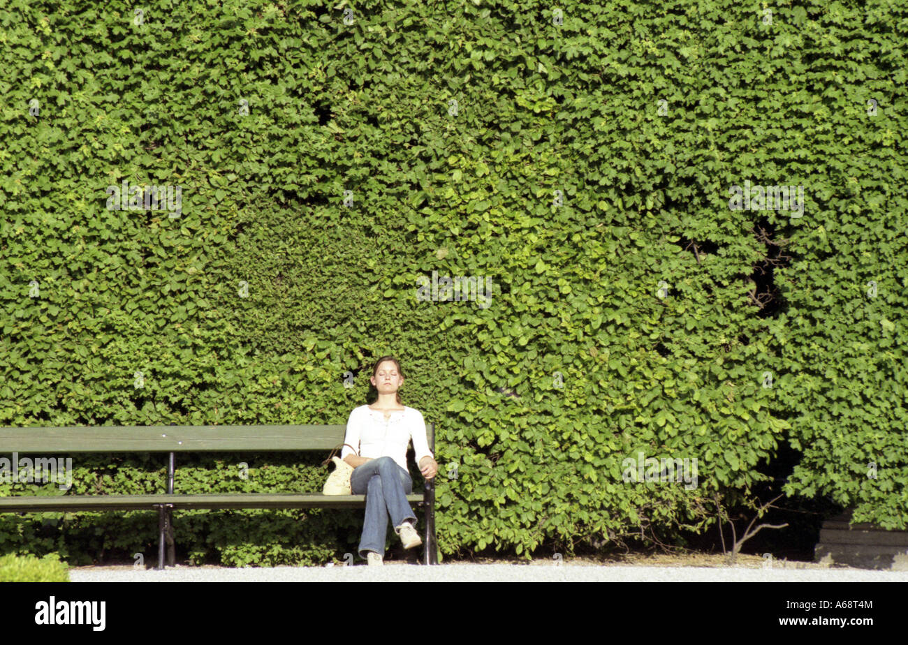 Female relaxing on bench in sun in Vienna, Austria Stock Photo - Alamy