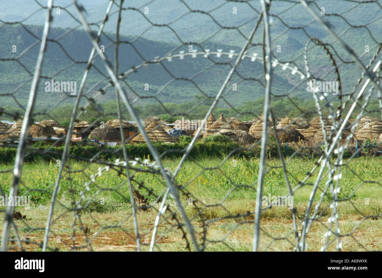 View of a Sudanese refugee camp through barbed wire fence, Lokichoggio ...