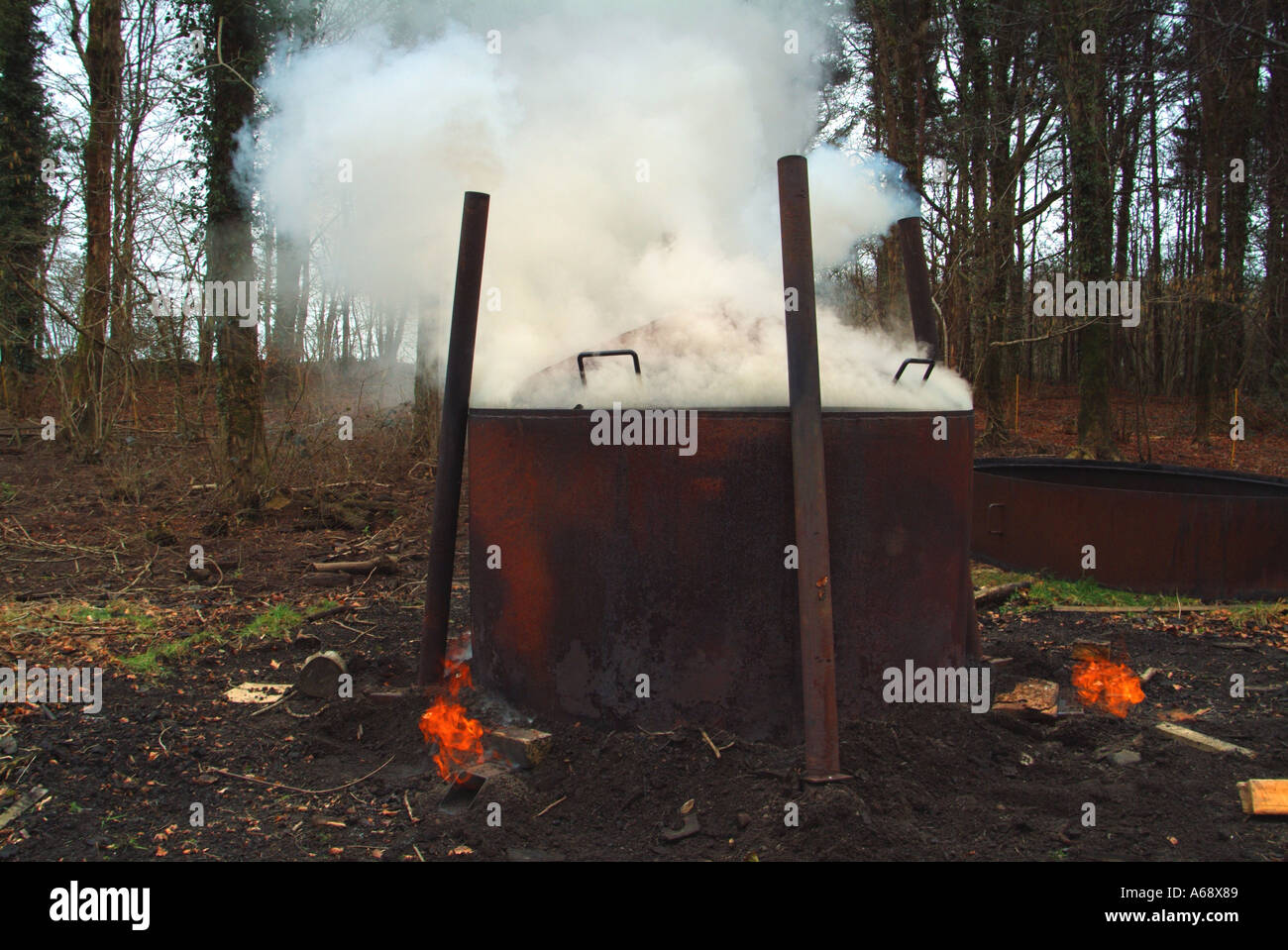 Smoke pouring from a charcoal kiln Devon UK Stock Photo - Alamy
