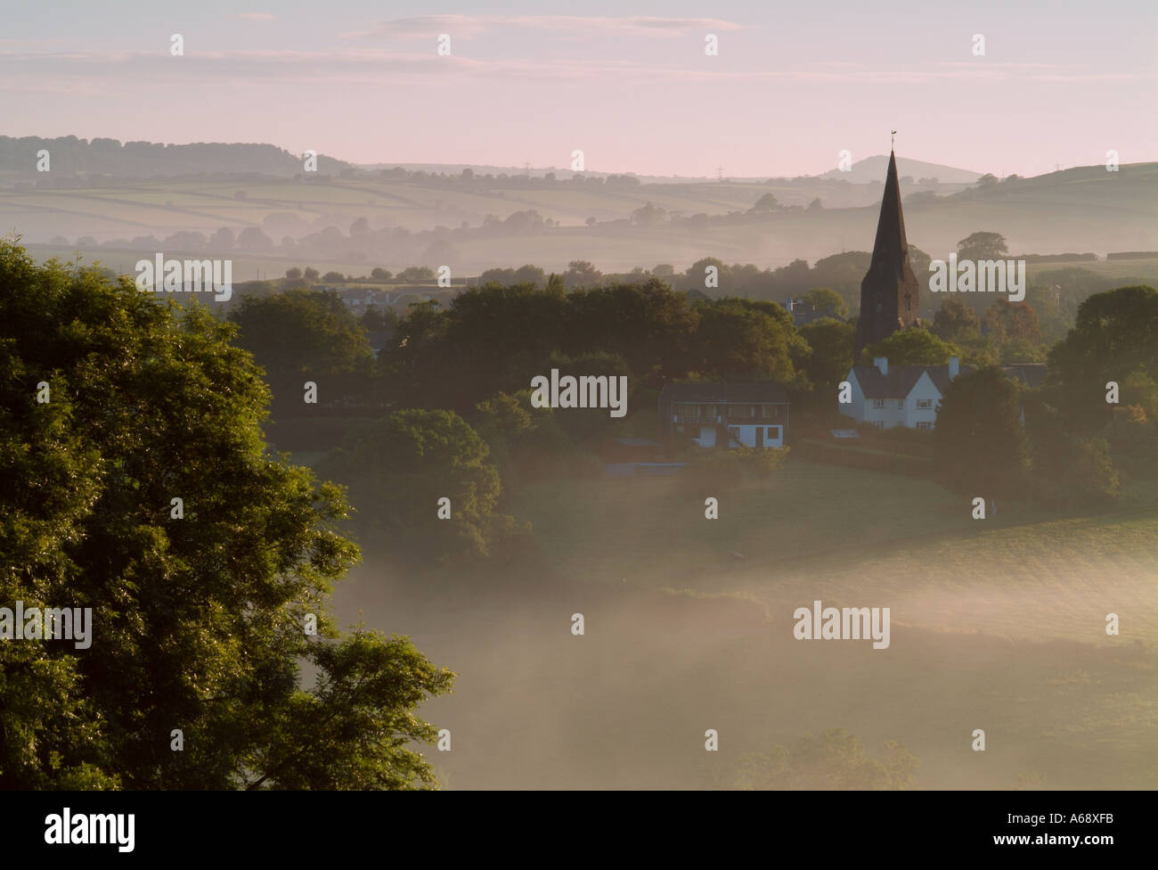 Misty dawn over Modbury village Devon UK Stock Photo - Alamy