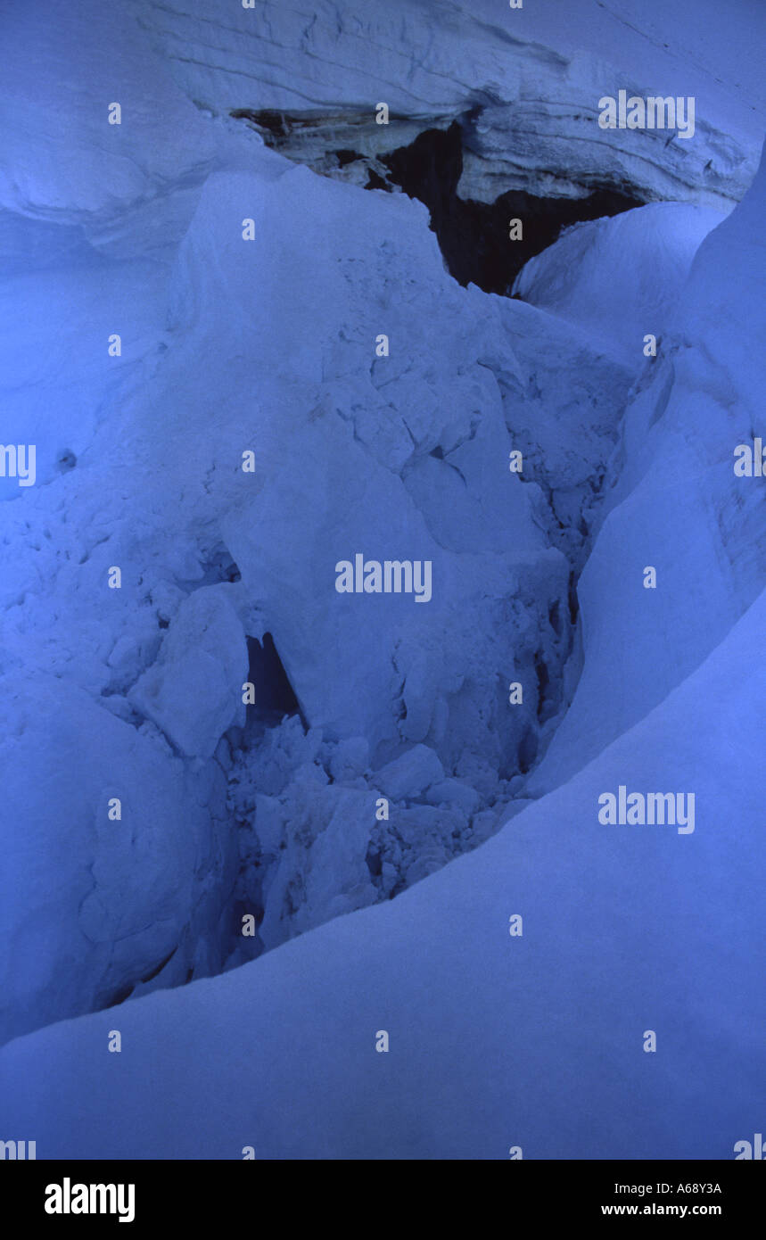 A crumbling bridge of snow and ice provides a passage across a large ...
