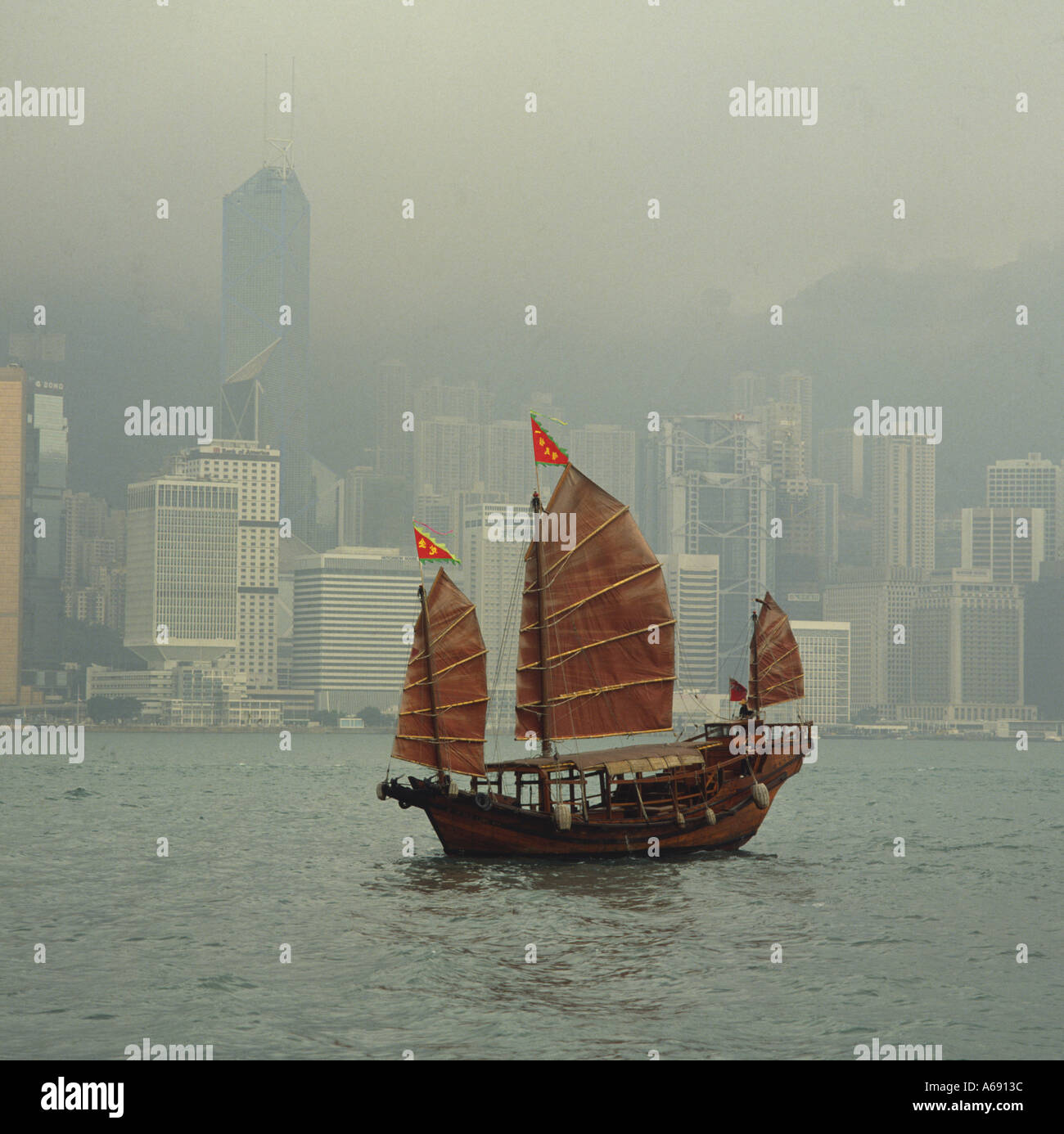 Traditional style Chinese sailing junk passes along the misty ...