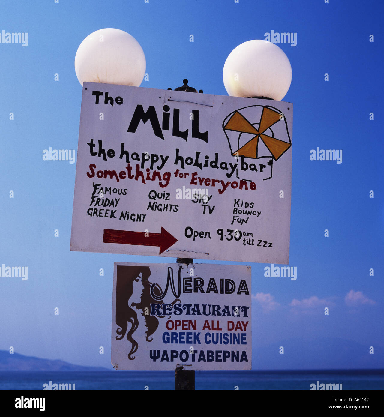 Local Greek bar and restaurant advertising boards at Alikes Beach ...