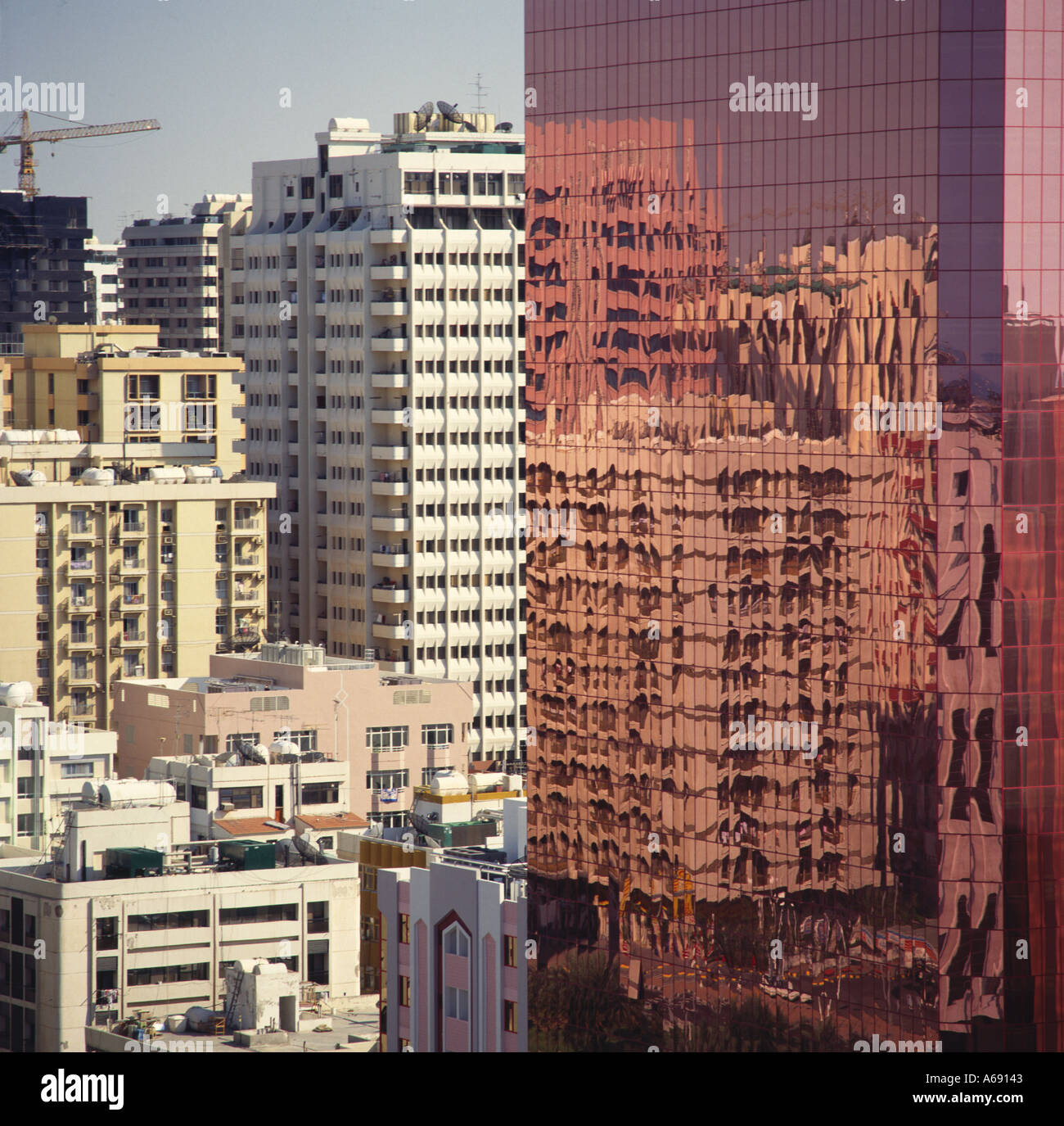 Gold tinted glass fronted modern office blocks reflects other city ...