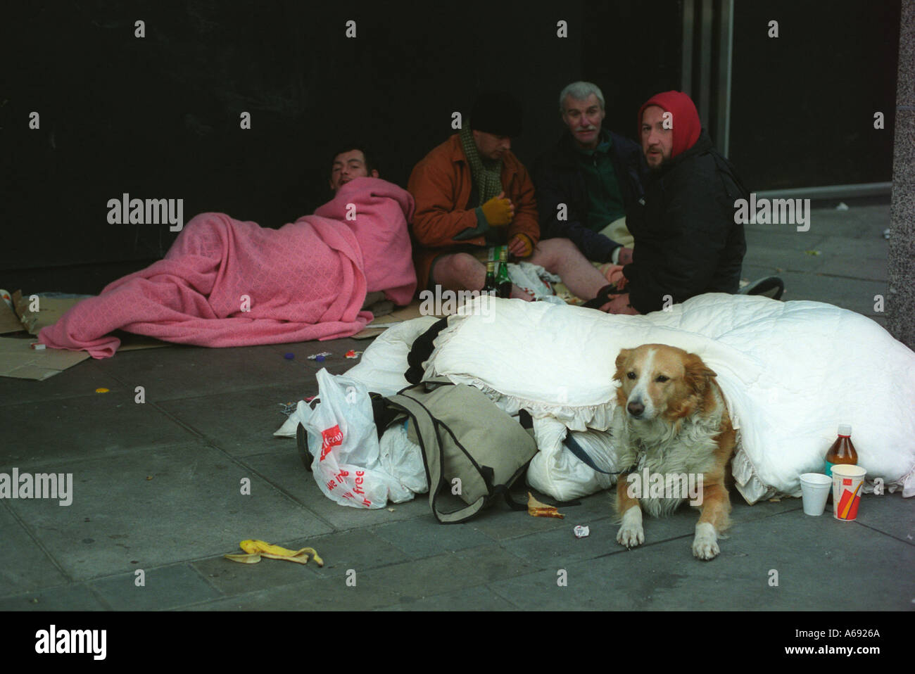 Group of homeless settling down for the night, Victoria Street, London ...