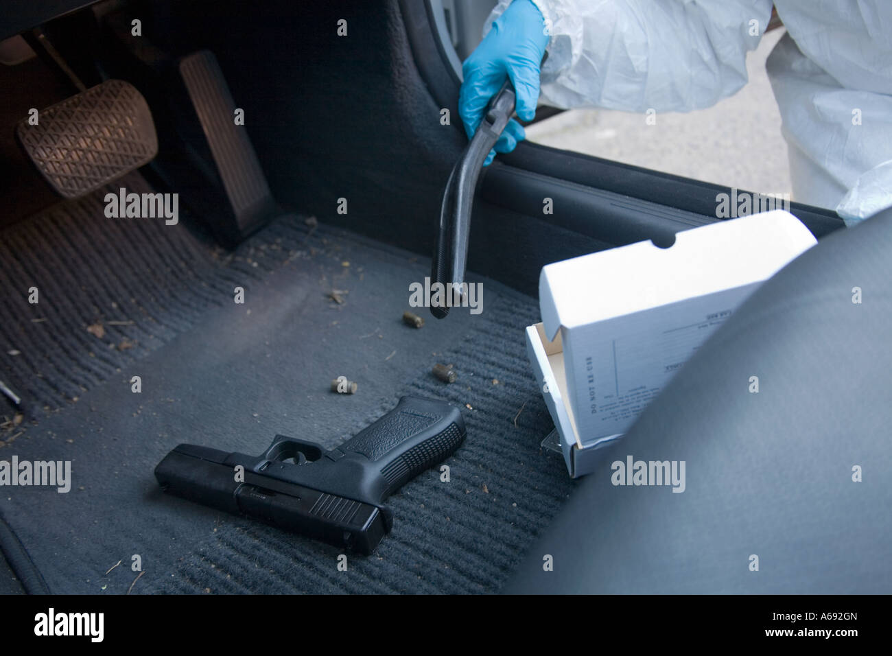 Firearm evidence being collected at crime scene with Sharp's Tongs ...