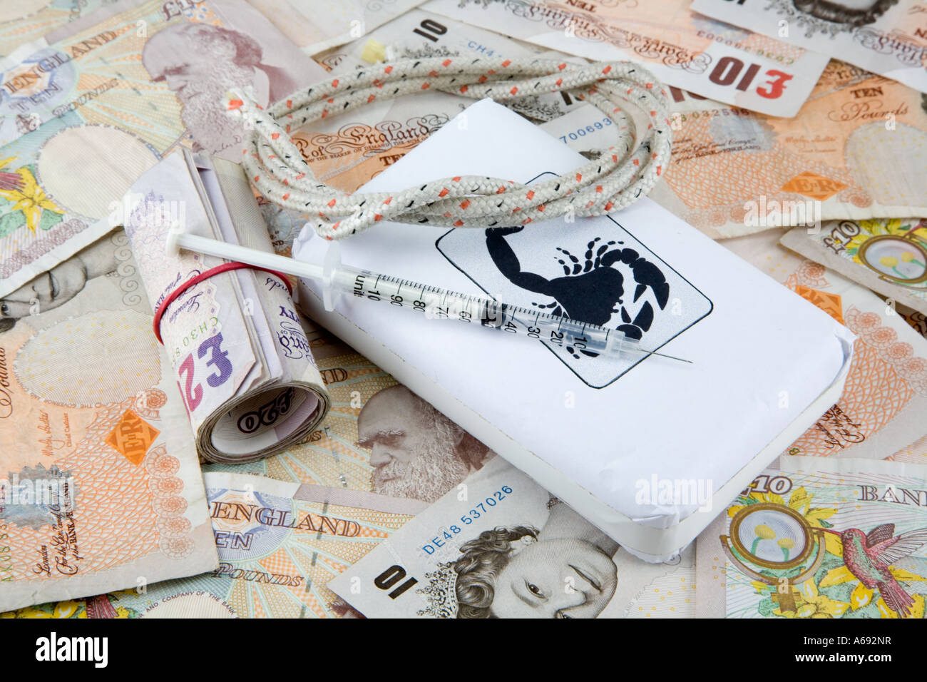 Packaged drugs with rope and syringe Stock Photo - Alamy