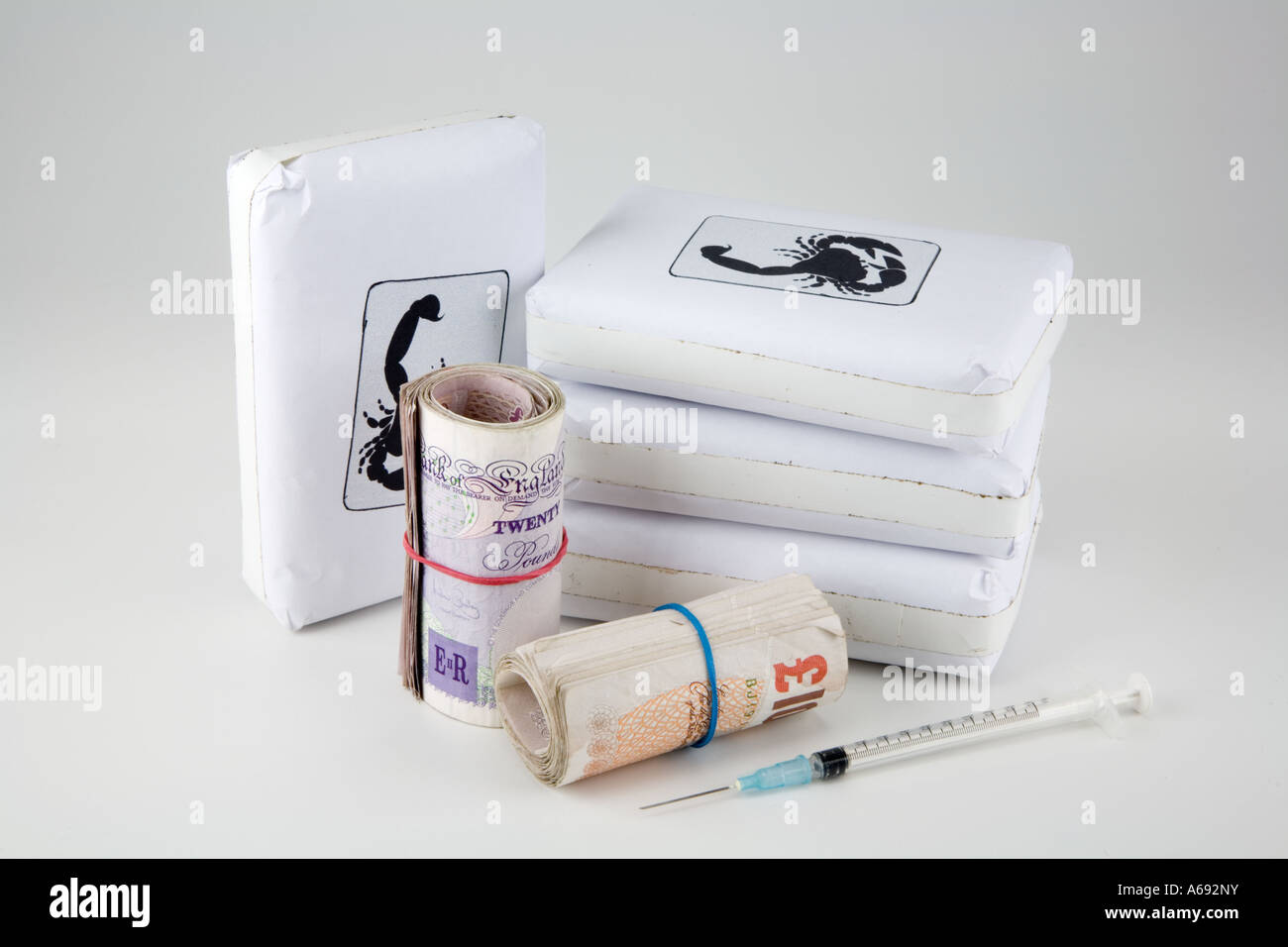 Packaged drugs with cash and syringe Stock Photo - Alamy