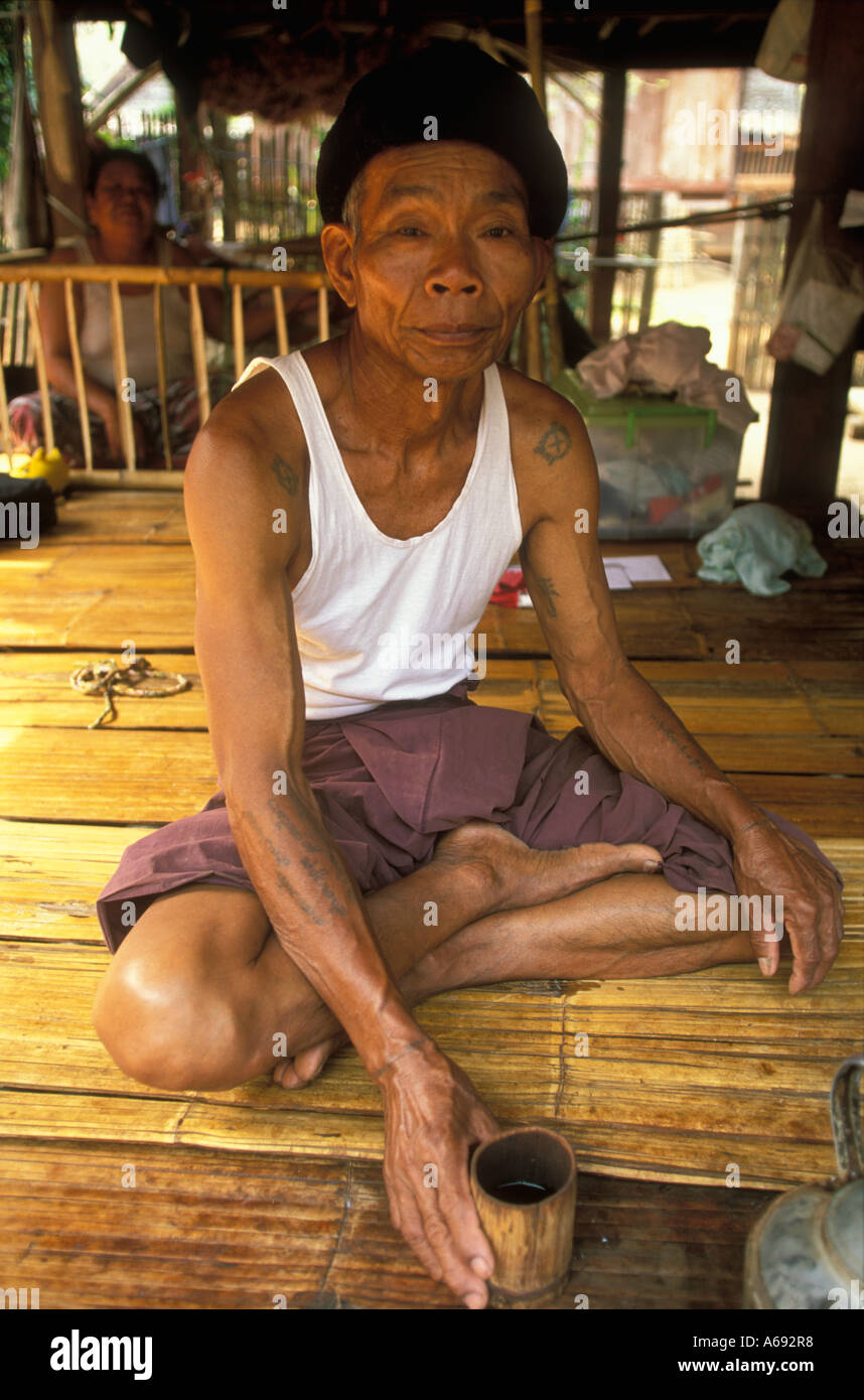 A Shan man drinking tea out of a bamboo cup in his home just outside of ...