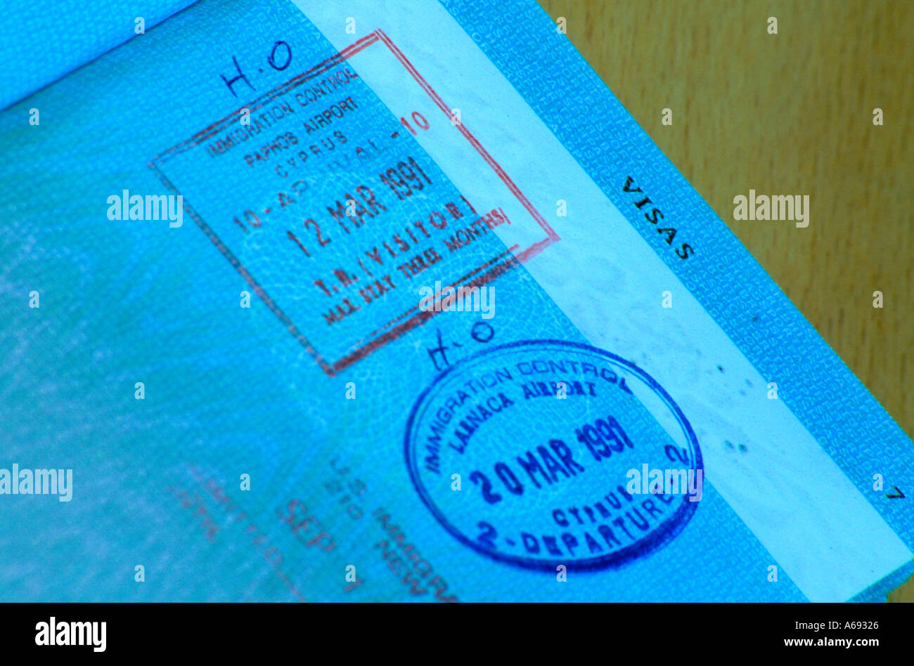 A British UK passport open at page with Cyprus entry and exit stamps ...