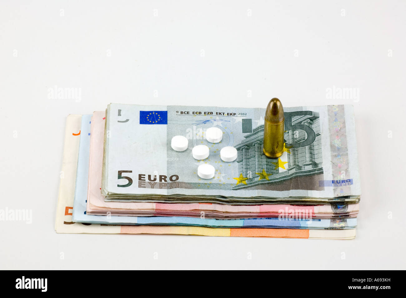 Euro cash and drugs, bullet and Ecstasy tablets Stock Photo - Alamy