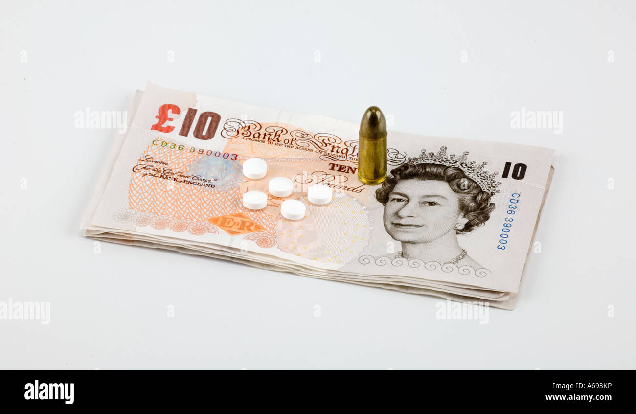 UK cash and drugs, bullet and Ecstasy tablets Stock Photo - Alamy