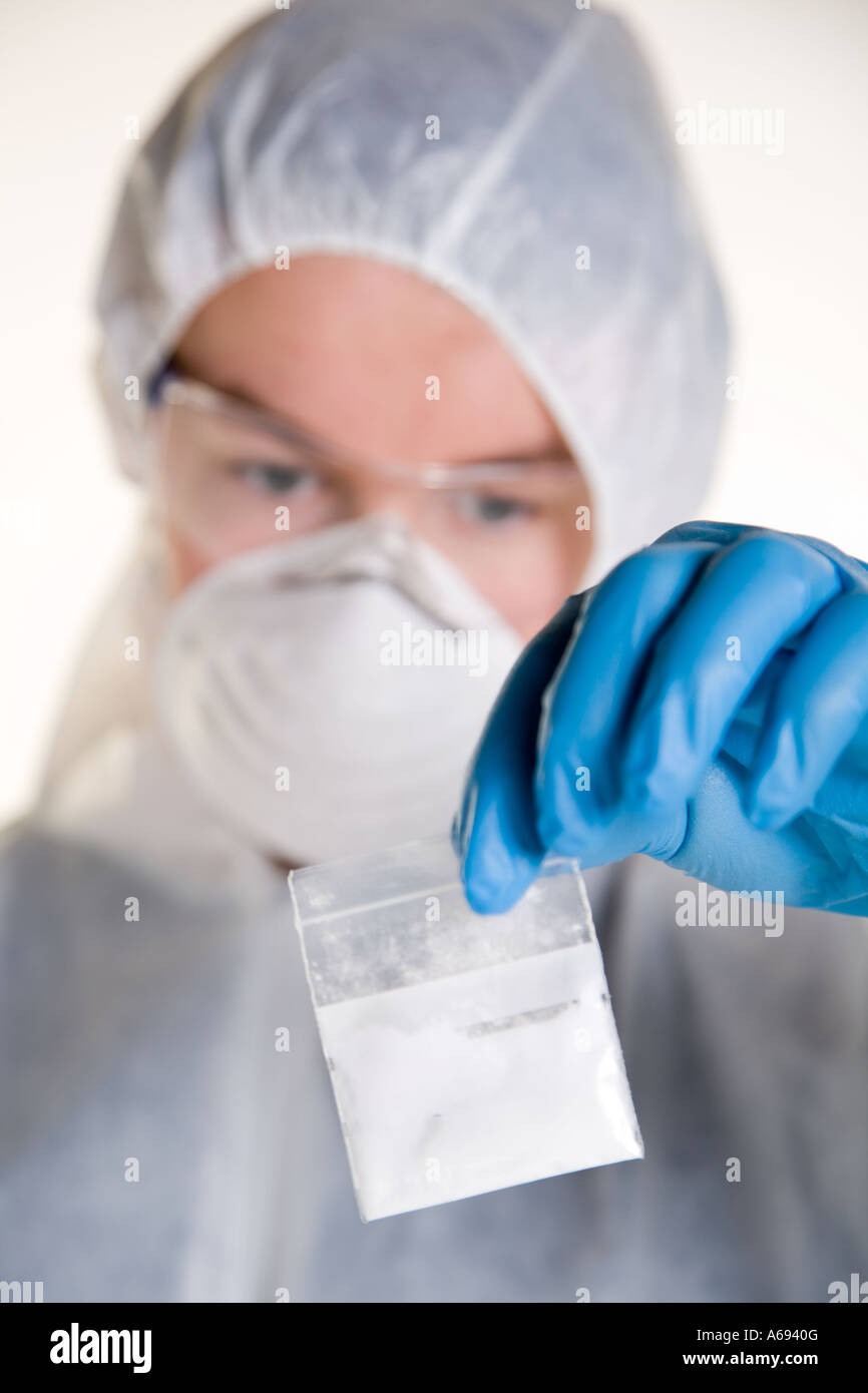 Crime scene officer showing packet of white powder heroine Stock Photo ...