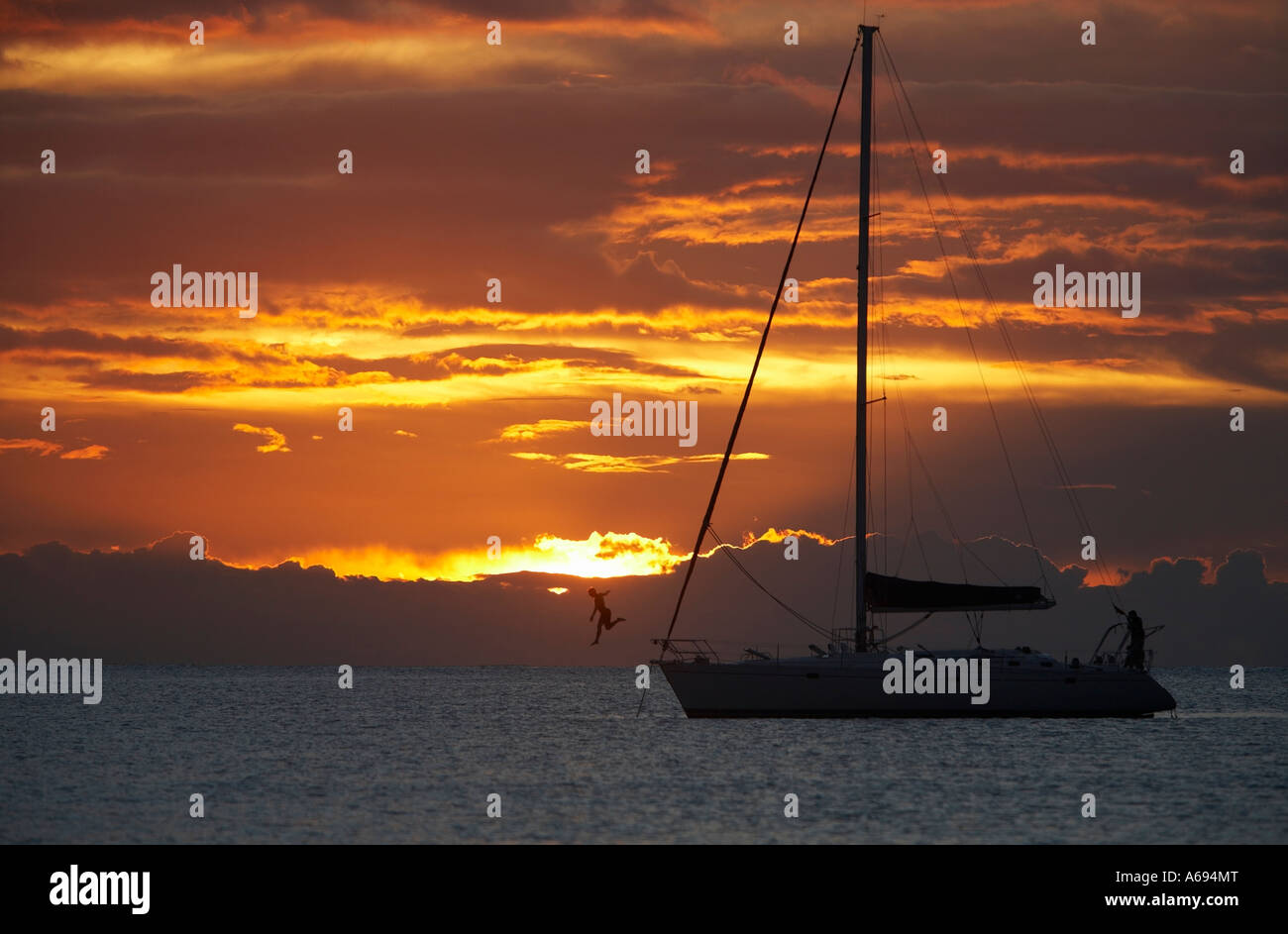 man jumping from sail boat boat in Antigua, leeward, islands Stock ...