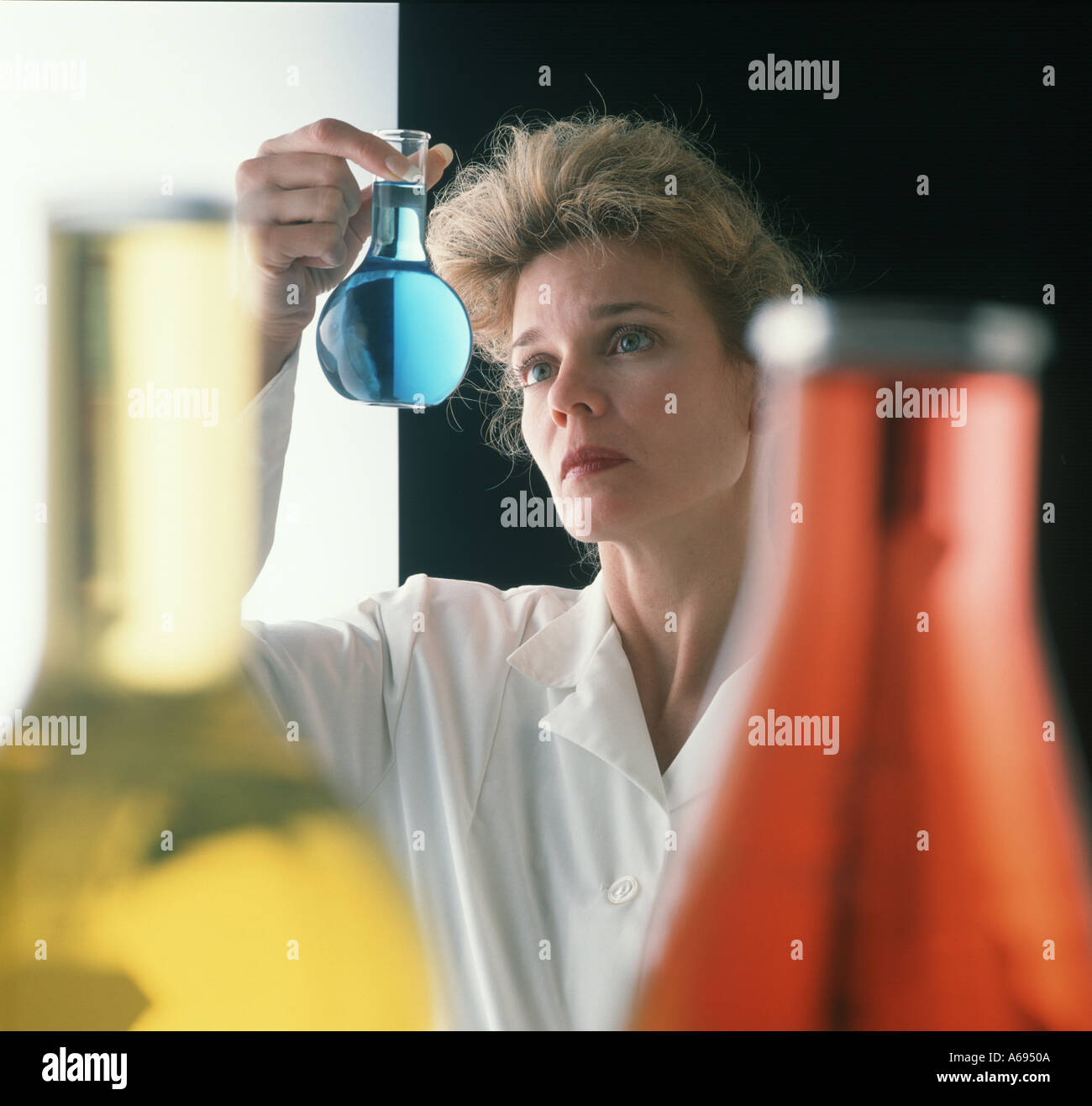 medical Technician and beakers in lab setting Stock Photo - Alamy