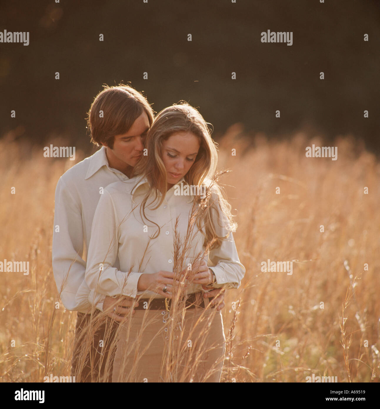 romantic couple hugging in field Stock Photo - Alamy