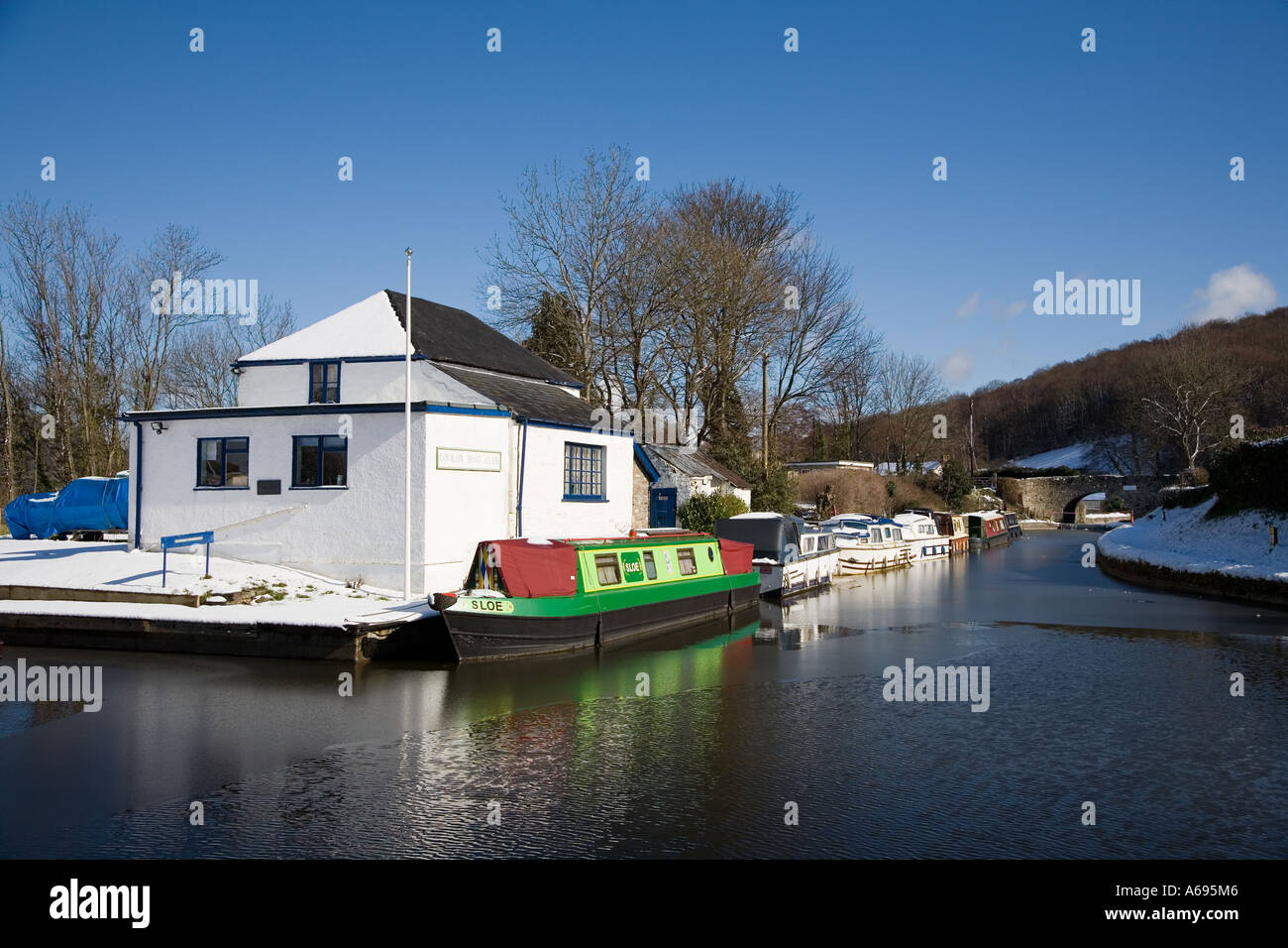 Boat club and canal boats and barges on canal in winter Govilon Brecon ...