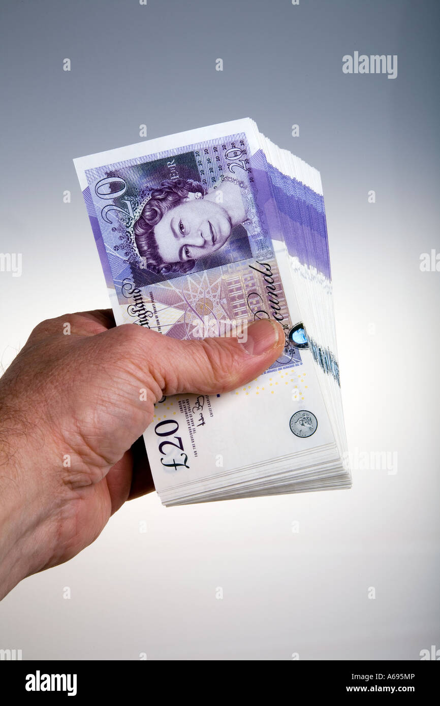 Hand holding fan of twenty 20 pound notes new 2007 design Stock Photo ...