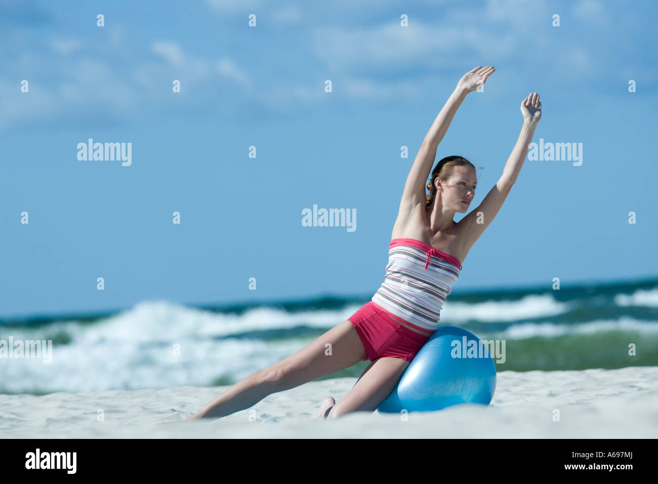 woman with fitness ball on beach Stock Photo - Alamy