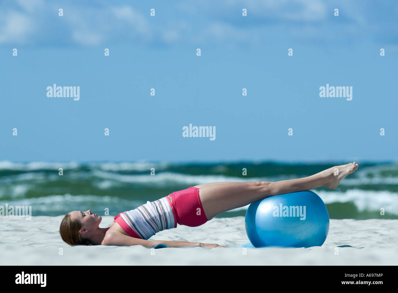 woman with fitness ball on beach Stock Photo - Alamy