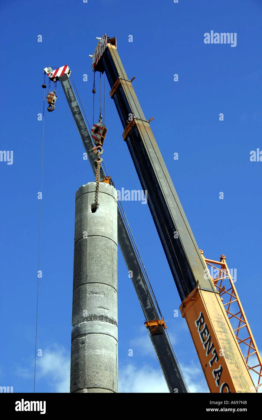 extending mobile crane in use during removal of a chimney Stock Photo ...