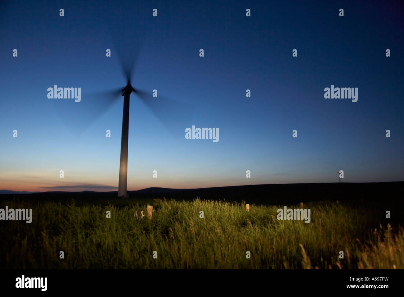 Spinning wind turbine at dusk Stock Photo - Alamy