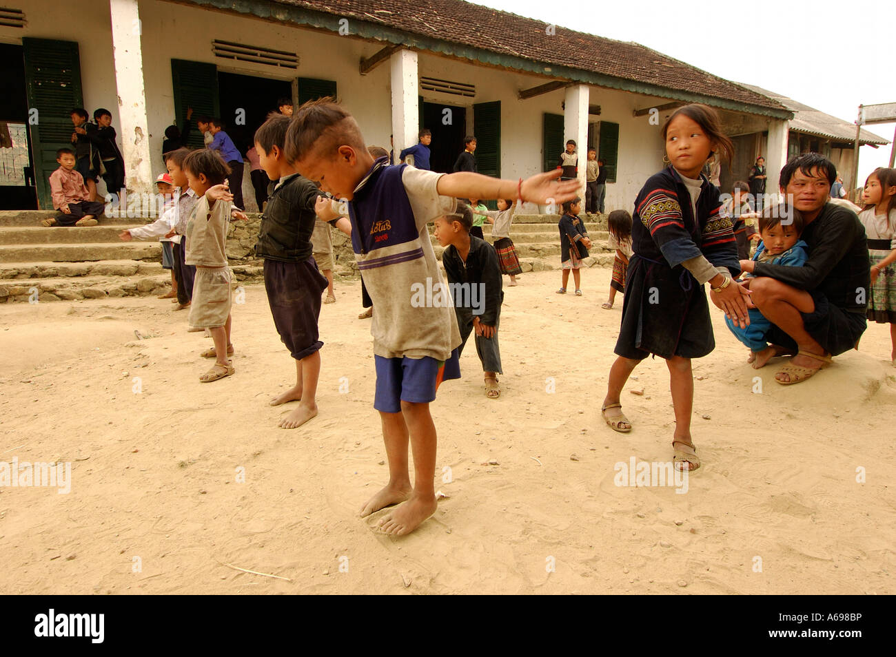 Young Black Hmong children in traditional cloth practice physical ...