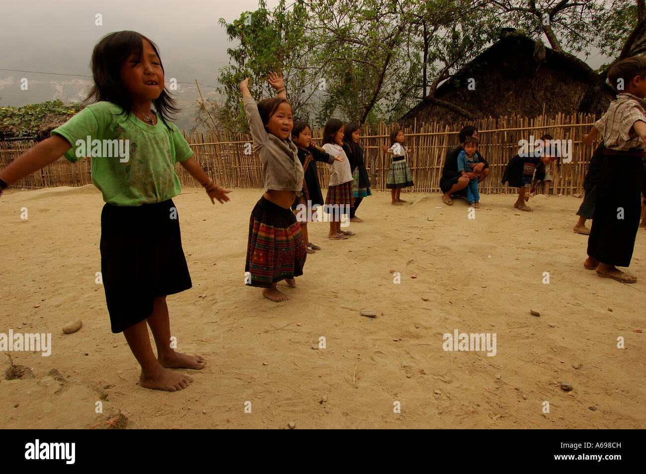 Young Black Hmong children in traditional cloth practice physical ...