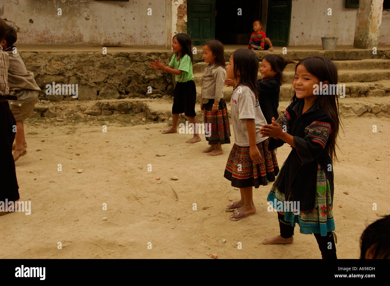 Young Black Hmong children in traditional cloth practice physical ...