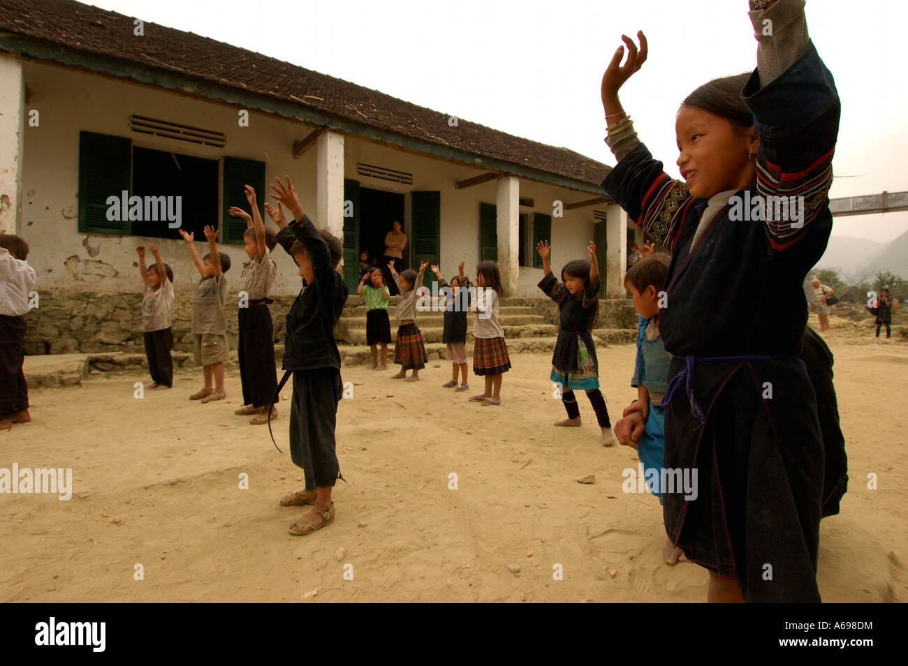 Young Black Hmong children in traditional cloth practice physical ...