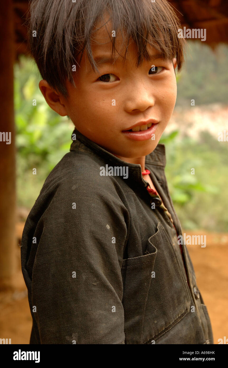 A Blue Hmong indigenous boy wearing traditional cloth proudly stands in ...