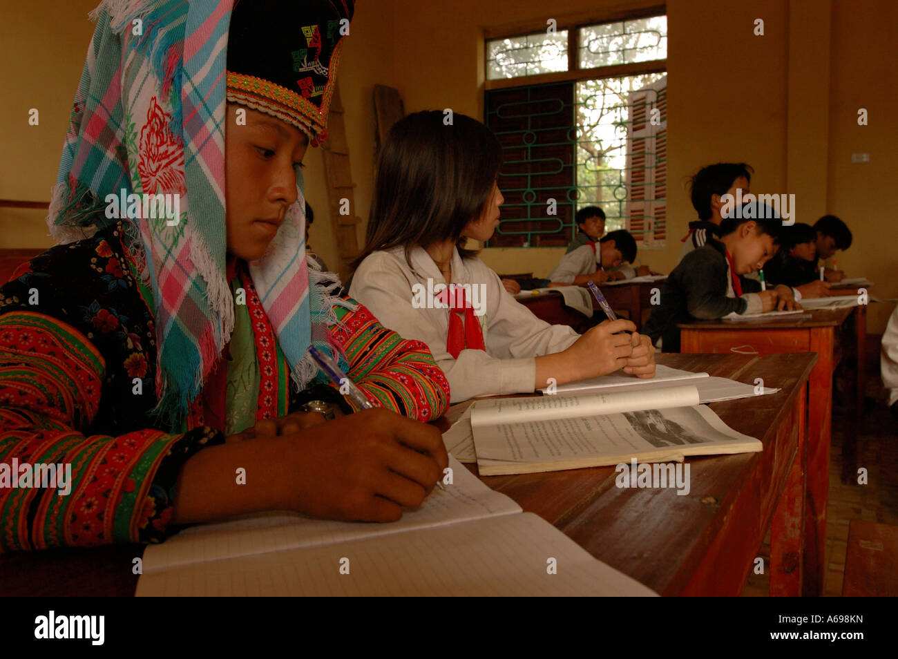 A Blue Hmong indigenous girl dressed in colorful traditional clothing ...
