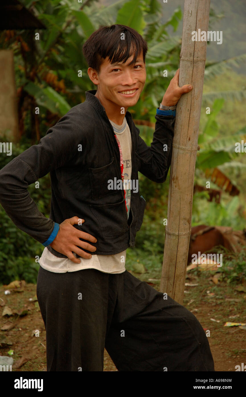 A Blue Hmong indigenous man wearing traditional cloth proudly stands in ...