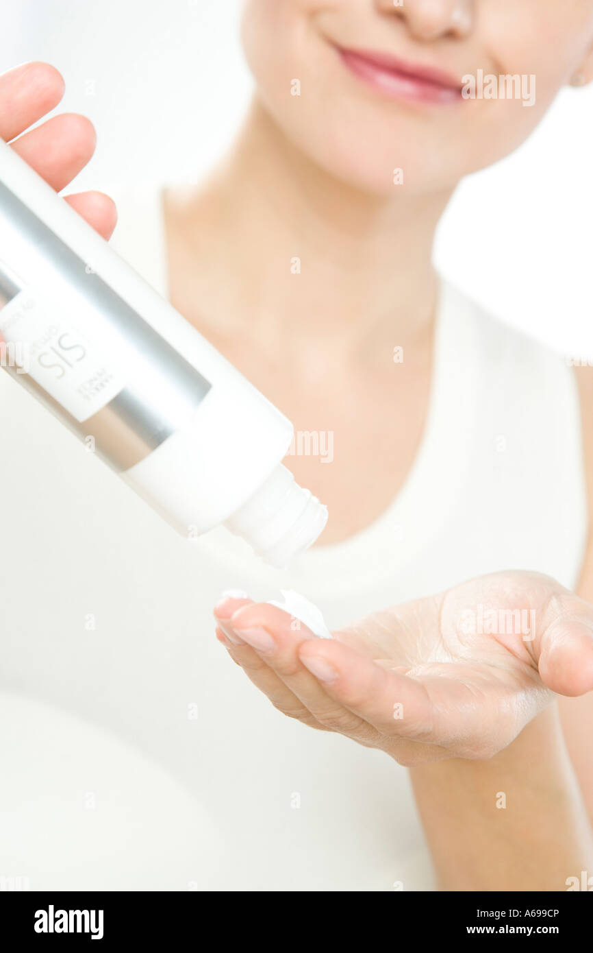 Woman putting face cream container hi-res stock photography and images ...